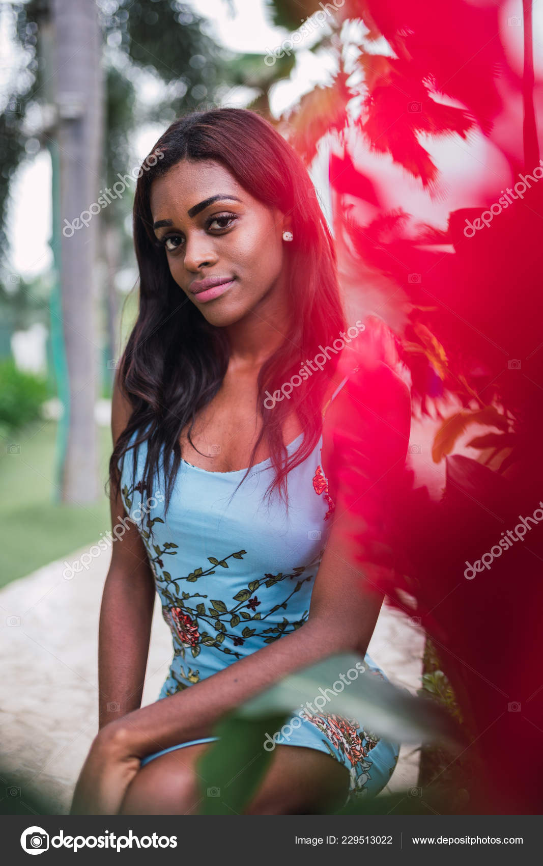 Young African American Woman Sitting Stone Fence Outdoors Foliage