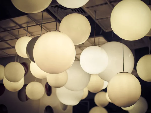 Lighting ball hanging from the ceiling on the black background - Stock ...