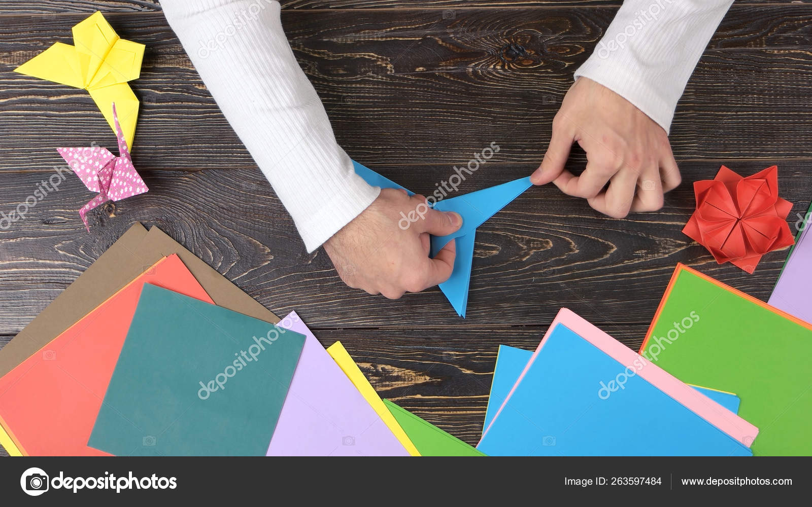 Man hands create beautiful origami toy. Stock Photo by ©Denisfilm 263597484