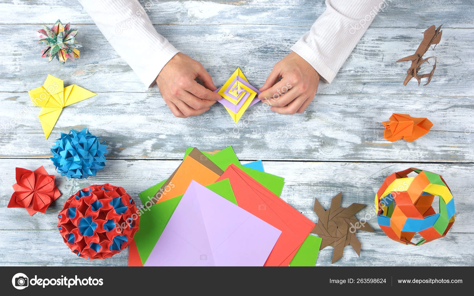 Man hands create beautiful origami toy. Stock Photo by ©Denisfilm 263598624
