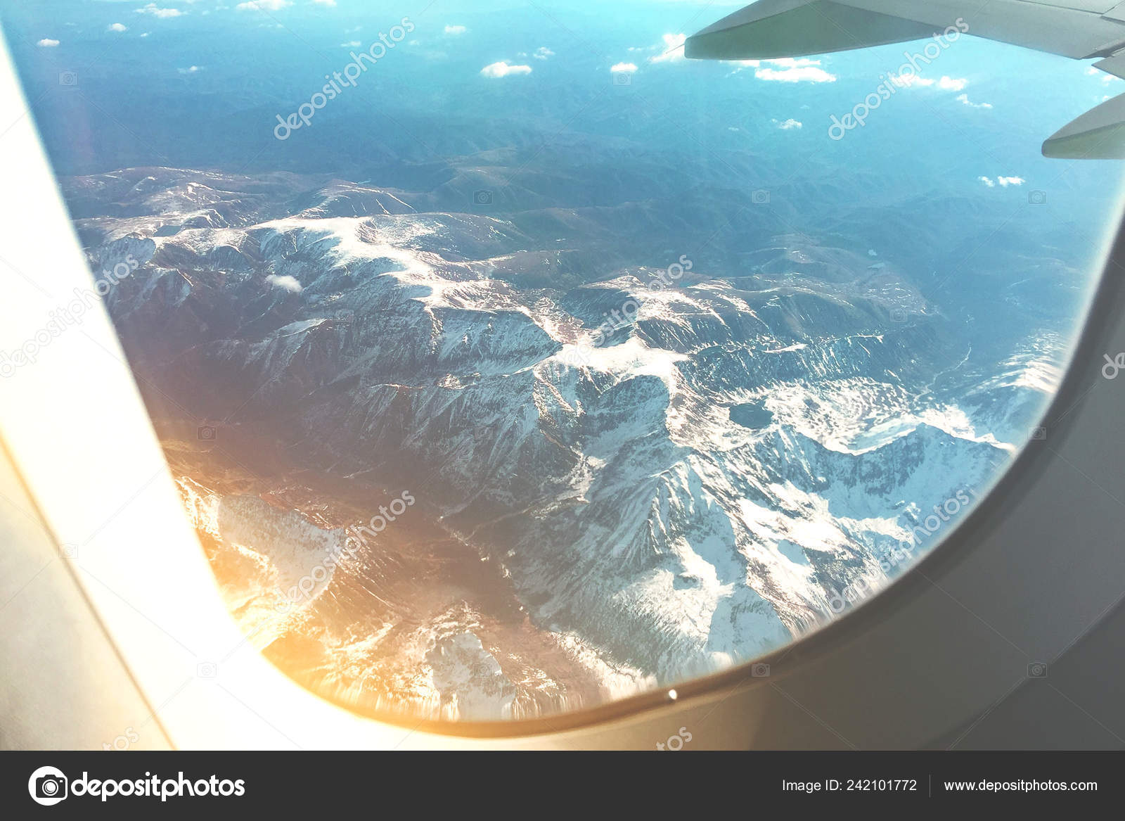 White Clouds Sky and Mountains as Seen Through Window of an Aircraft ...