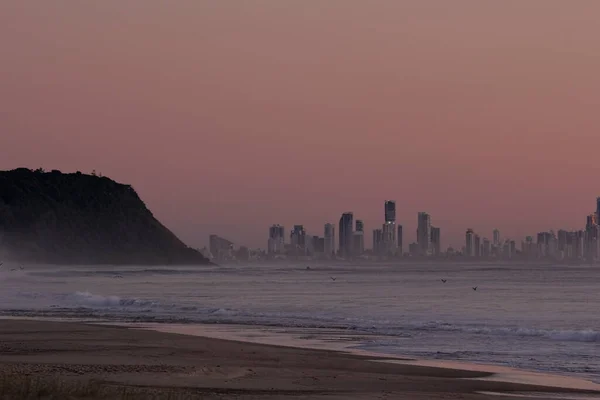 Surreal hazy pink sunset from bush fire smoke at the Gold Coast in ...