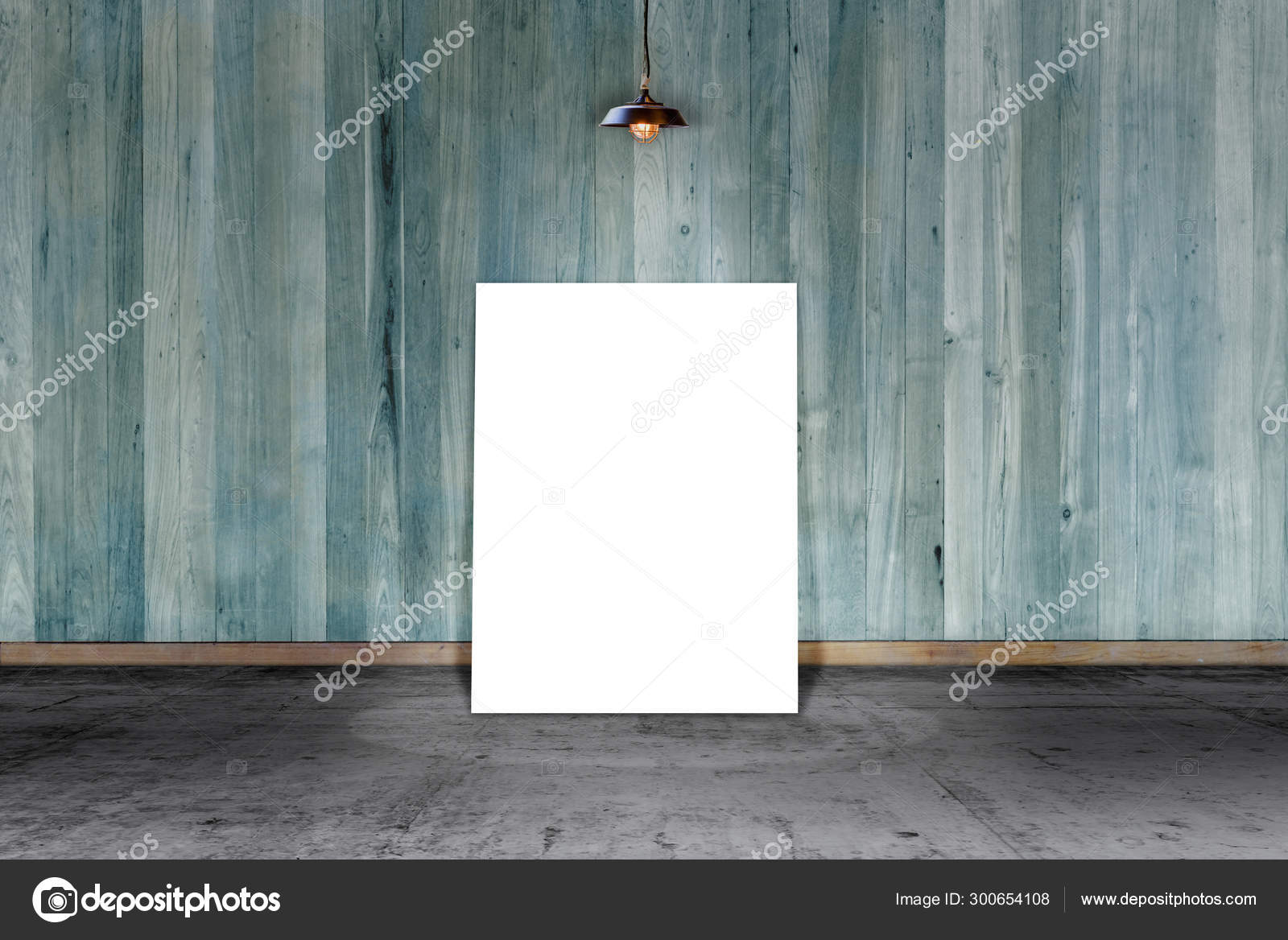 Poster standing on laminate flooring with lamp and wooden wall. write ...