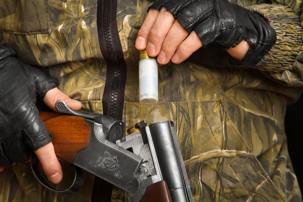 the hands of the shooter load a double-barreled shotgun - Stock Image ...