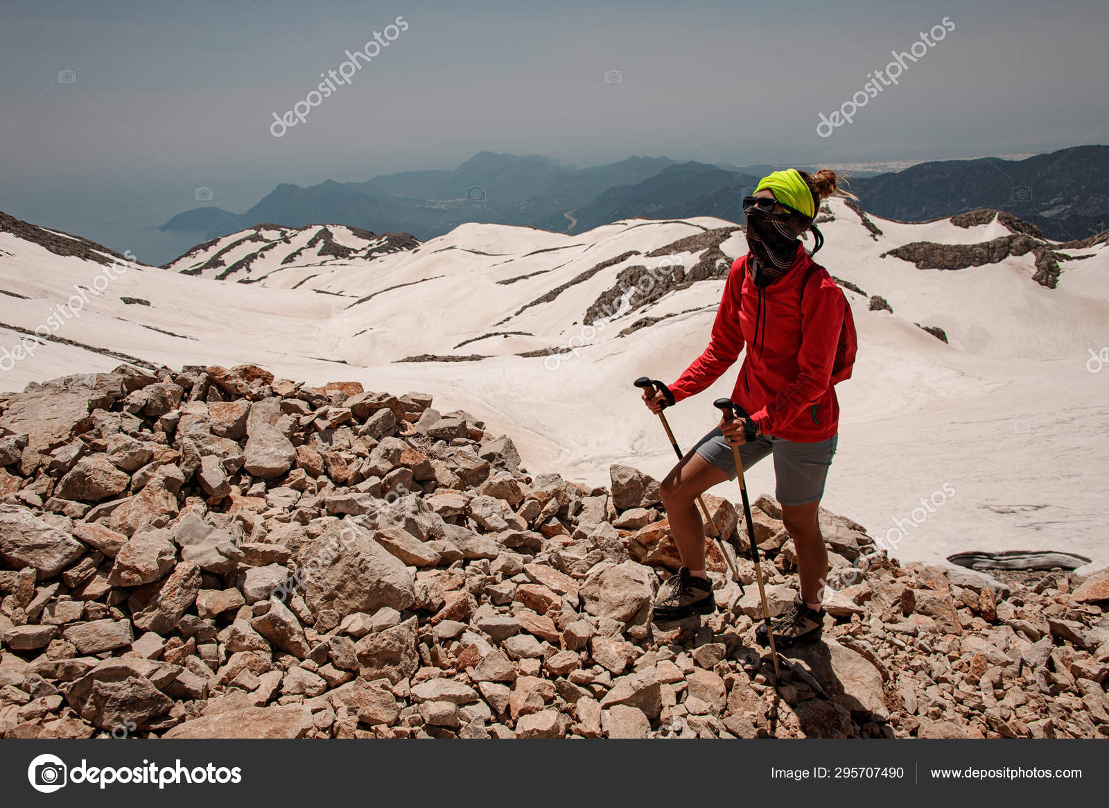 Female wanderer with walking sticks in mountains — Stock Photo ...