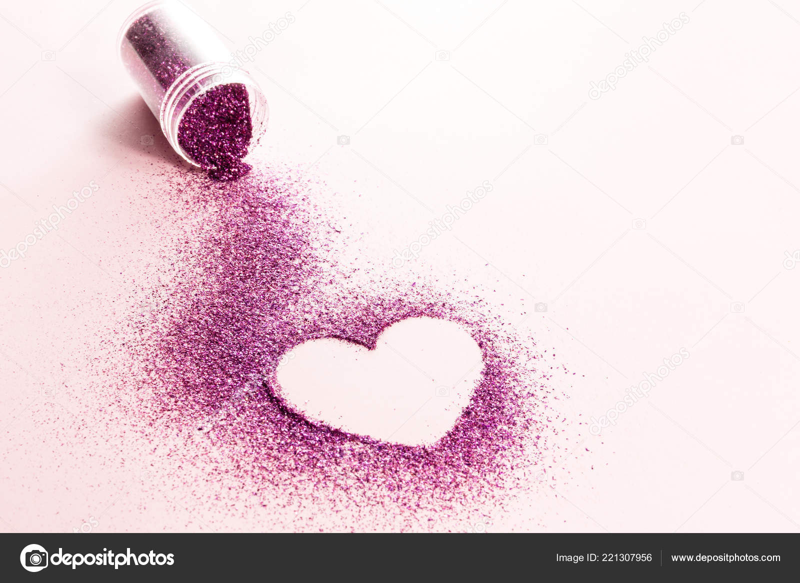 A jar with a track of scattered pink spangles on a pink background and ...