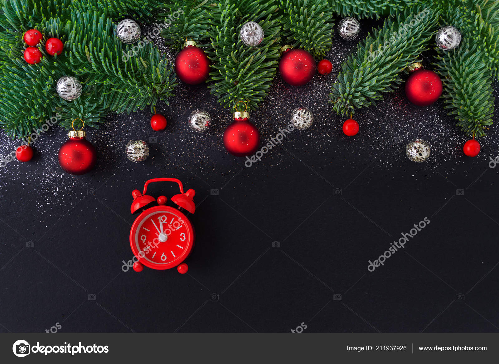 New years clock on black background with decoration, red berrys, bauble ...