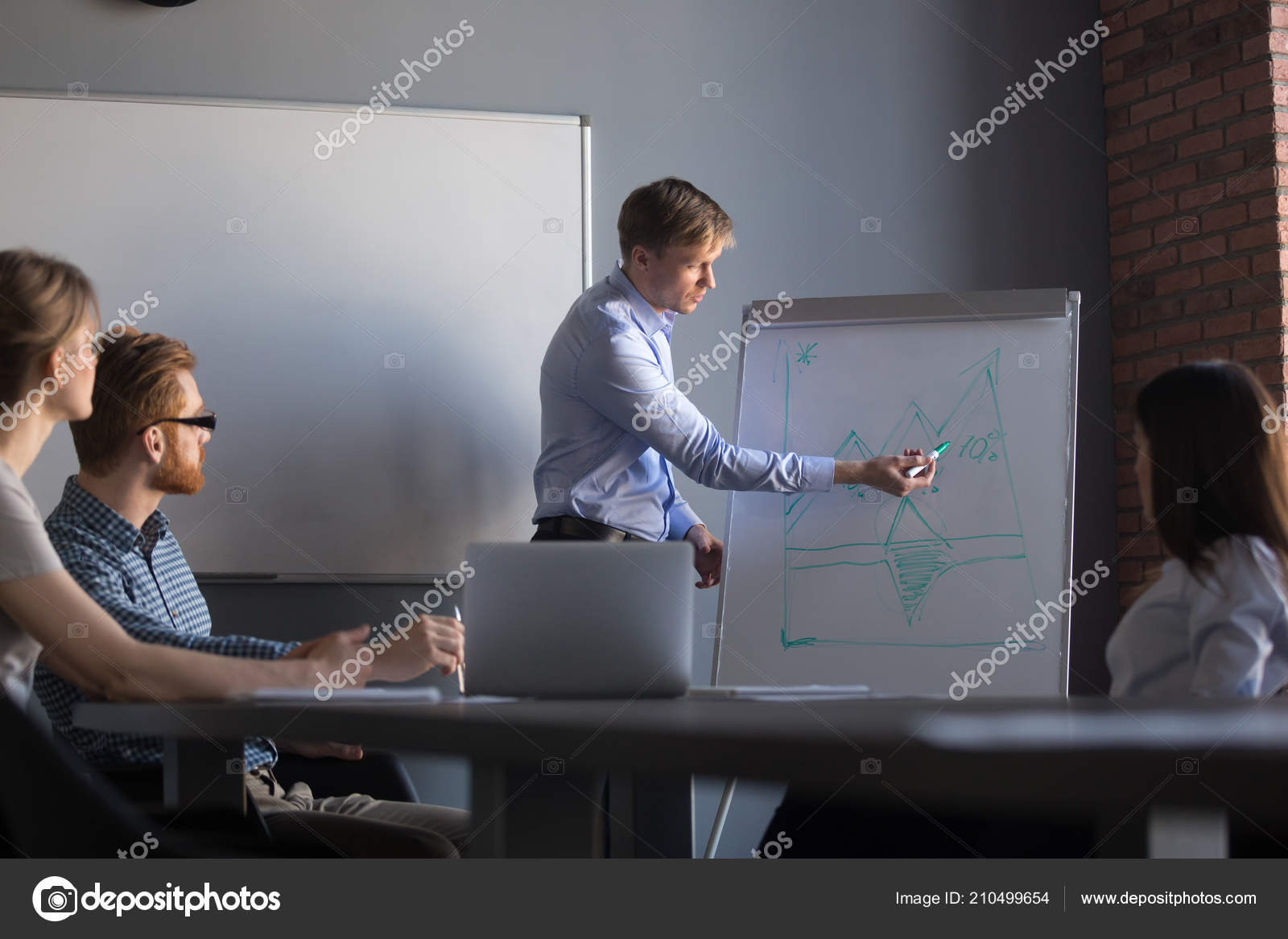 Male speaker giving flipchart presentation to colleagues — Stock Photo ...