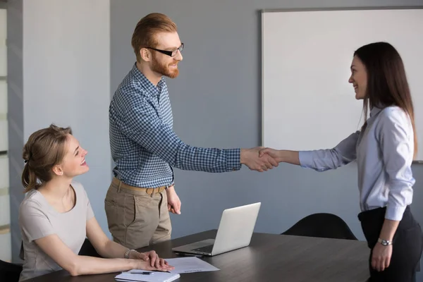 Smiling hr welcoming applicant at job interview with handshake - Stock ...