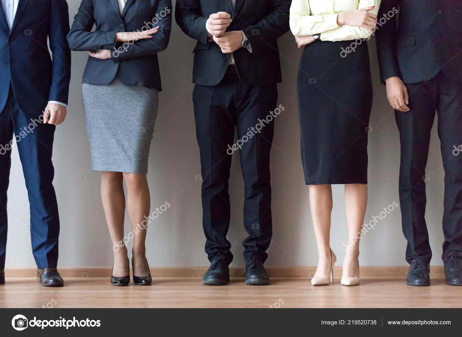 Diverse work team standing near office wall in queue — Stock Photo ...