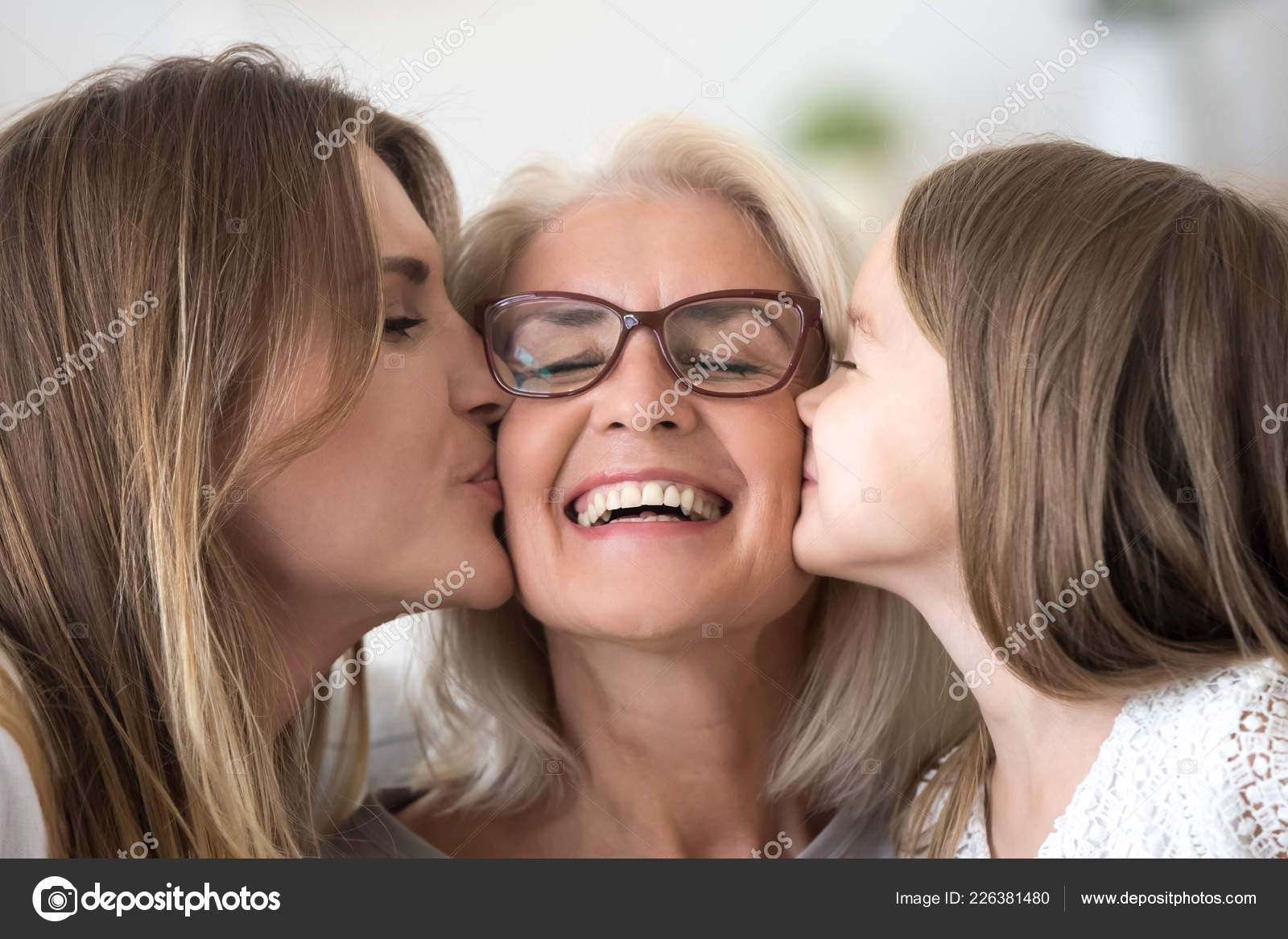 Grown Daughter And Granddaughter Kissing Happy Old Grandmother O Stock