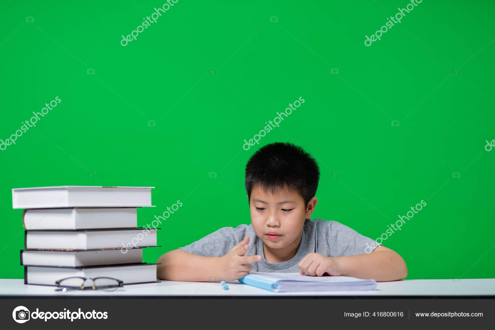 Asian Boy Doing Homework Green Screen Child Writing Paper Education ...