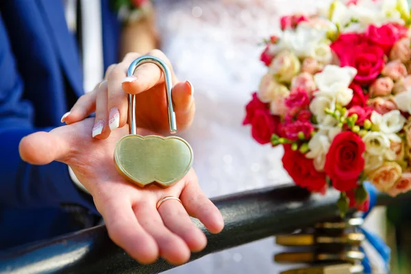 The decorative lock in hands of newlyweds, Space for text on lock ...