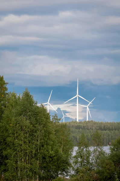 Wind turbines, converting the wind's kinetic energy into electrical ...
