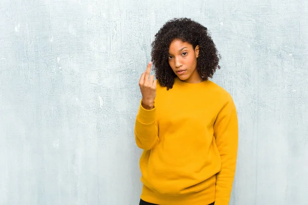 young pretty black woman feeling angry, annoyed, rebellious and ...