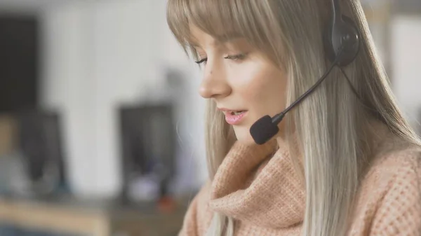 Customer service representative talking with customer with headphones ...