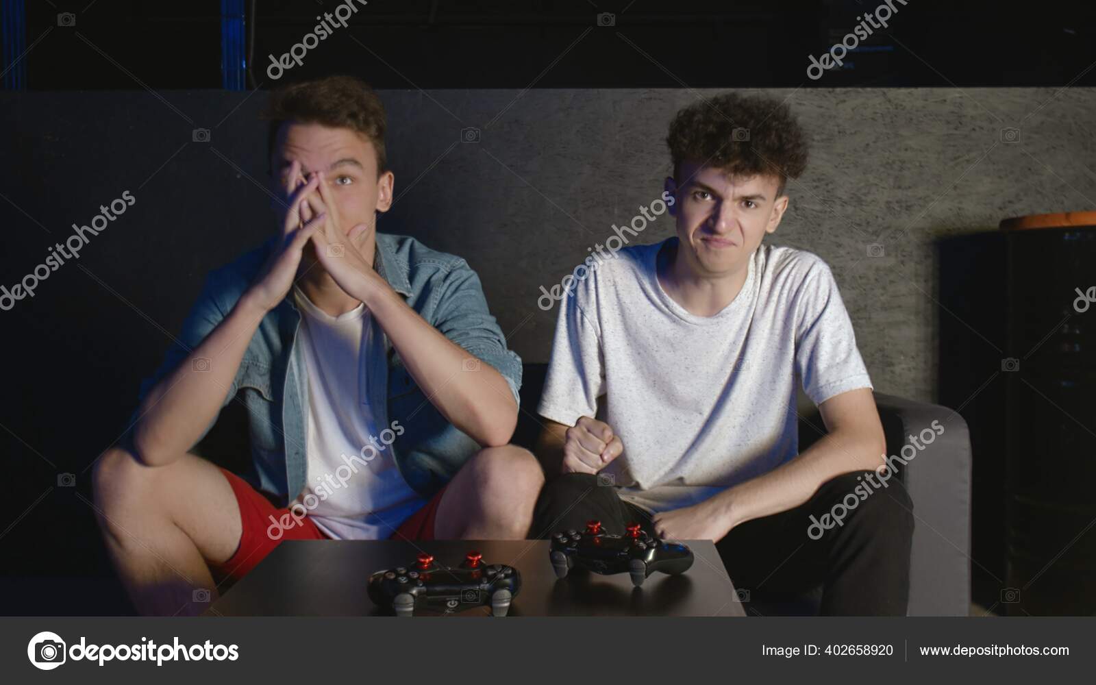 Two ANGRY guys are sitting on the couch in front of the TV and losing ...