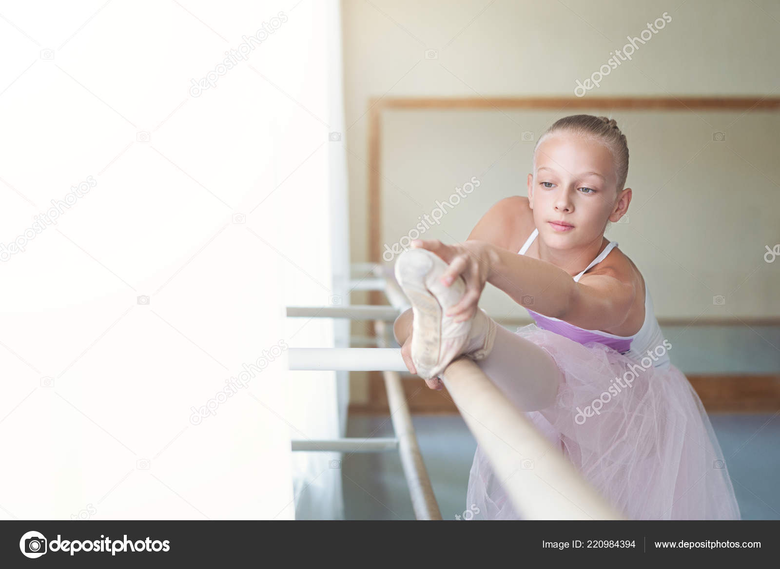 Little ballerina stretching in class near ballet barre Stock Photo by ...