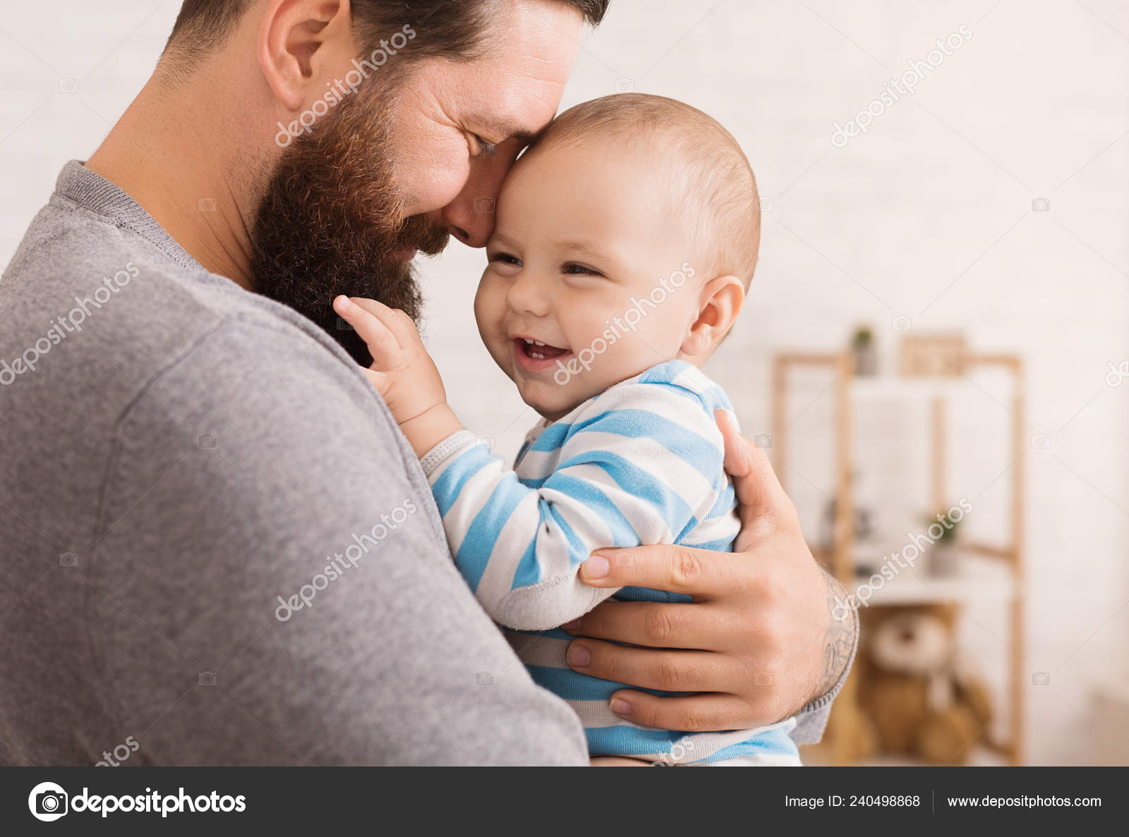 Loving father embracing his cute baby son — Stock Photo © Milkos #240498868