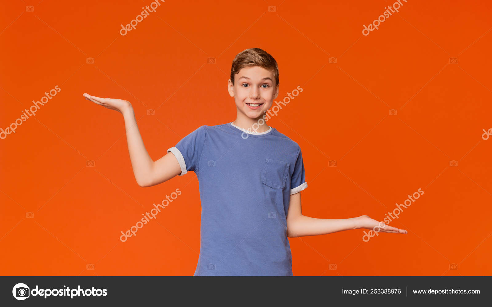 Hesitant boy spreading hands sideway with empty space Stock Photo by ...