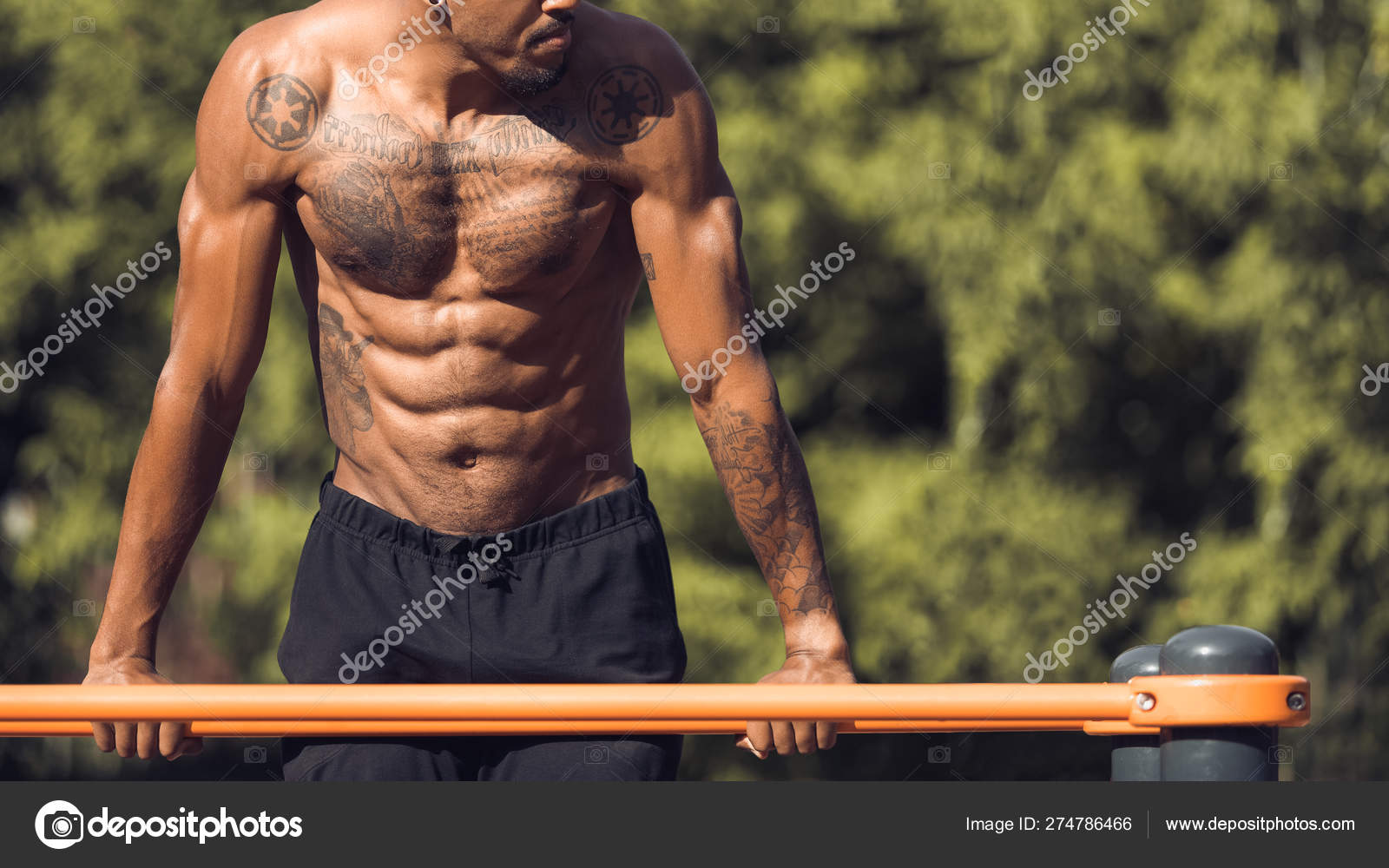 Muscular Guy Doing Street Workout On Bars In Park Stock Photo by ...
