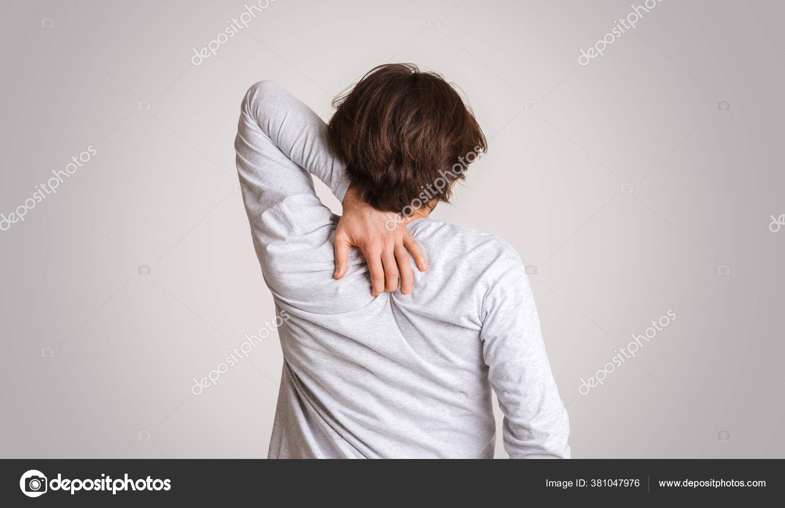 Itching and allergies. Guy scratches his back with hand isolated on ...