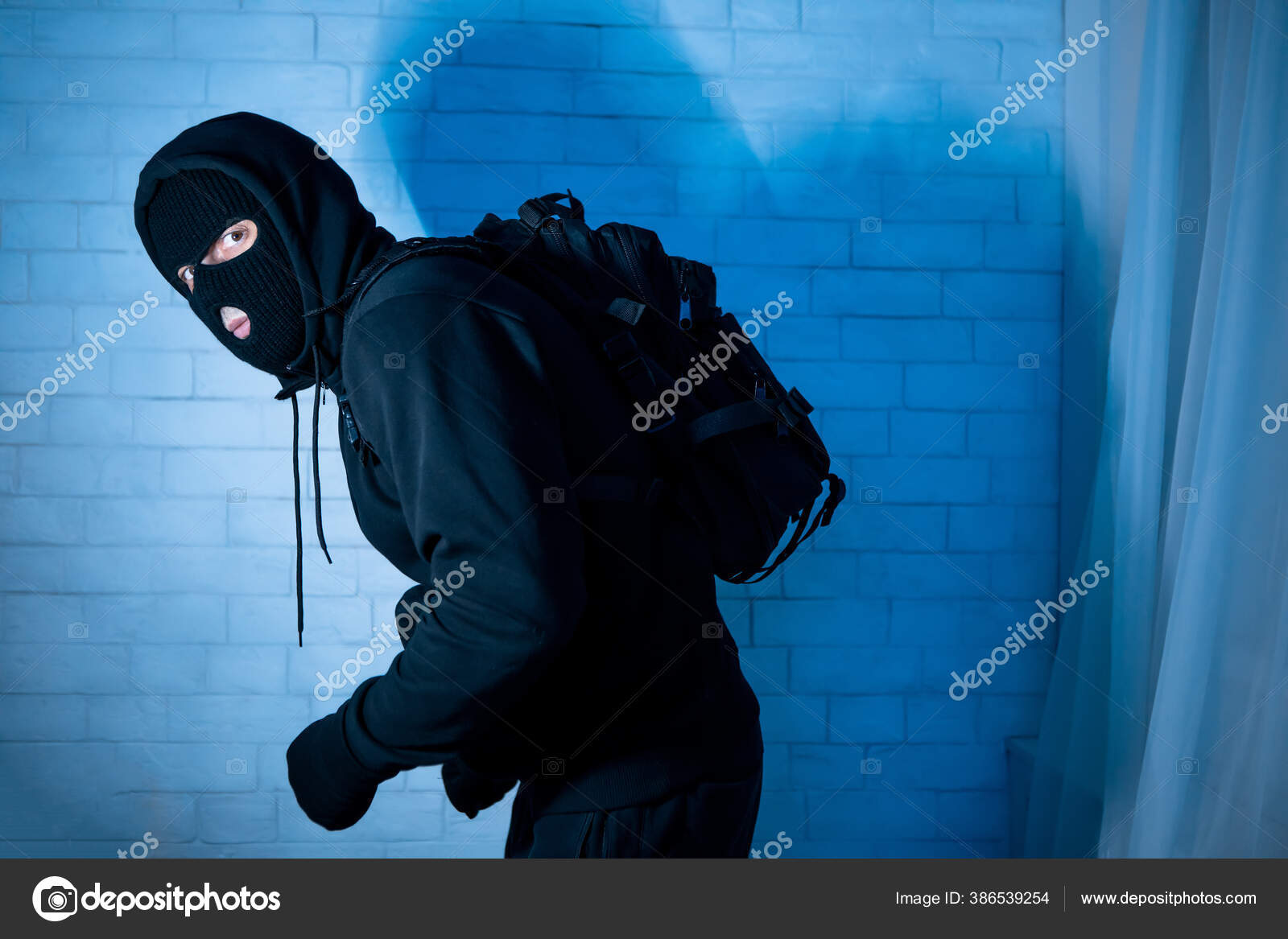 Sneaky robber ready to steal something at home Stock Photo by ©Milkos ...