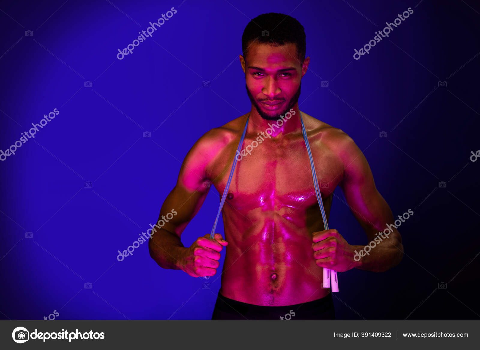 Muscular Man Posing With Jump Rope Standing In Studio Stock Photo by ...