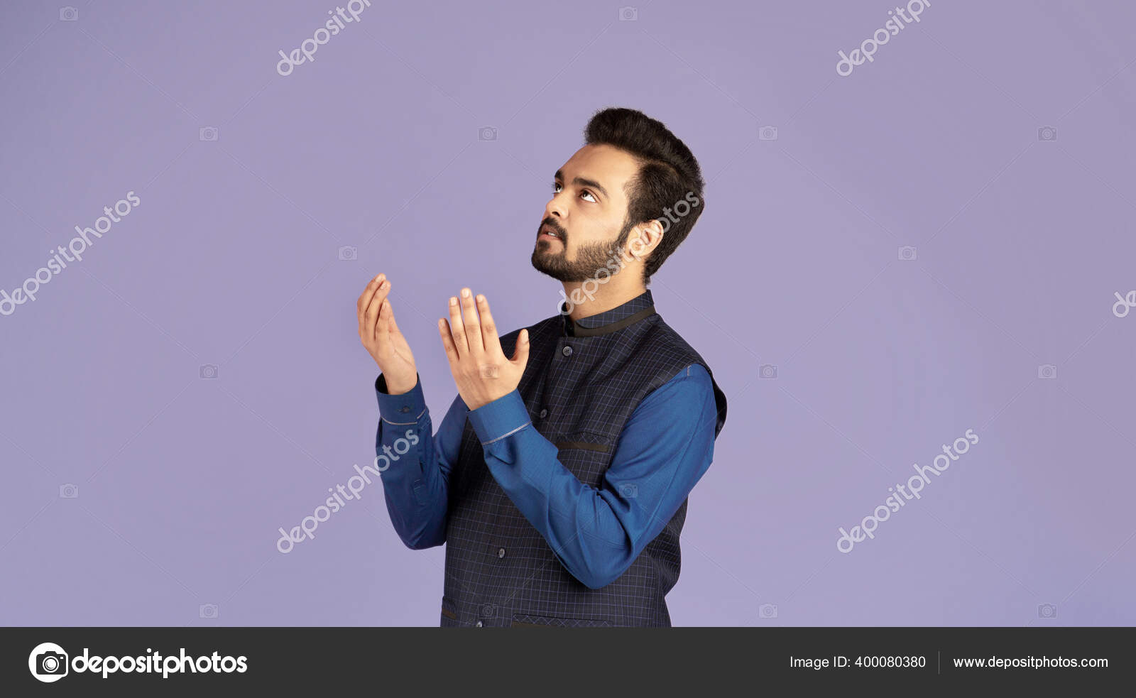 Indian man praying to God, asking for help or forgiveness on lilac ...