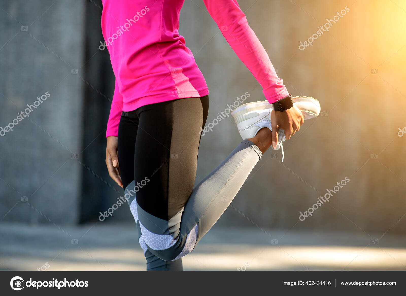 Unrecognizable african lady stretching legs over stoney wall Stock ...