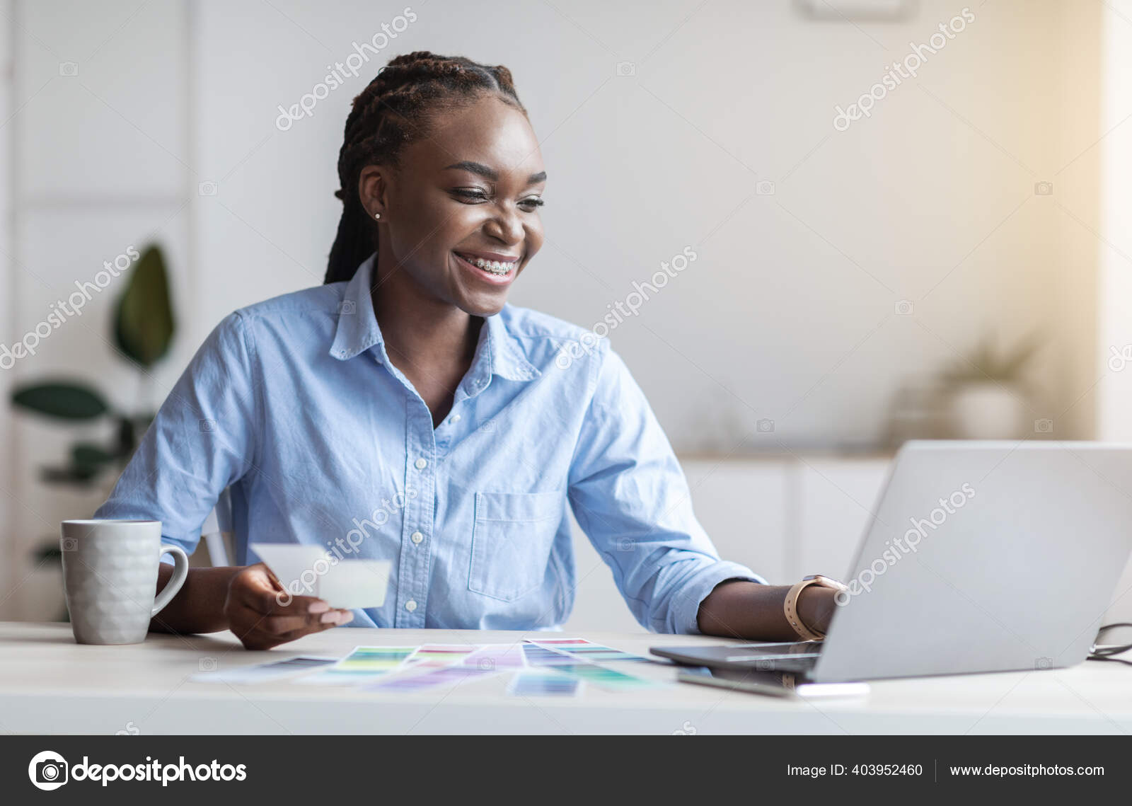 Black Woman Graphic Designer Working With Color Swatches And Laptop At ...
