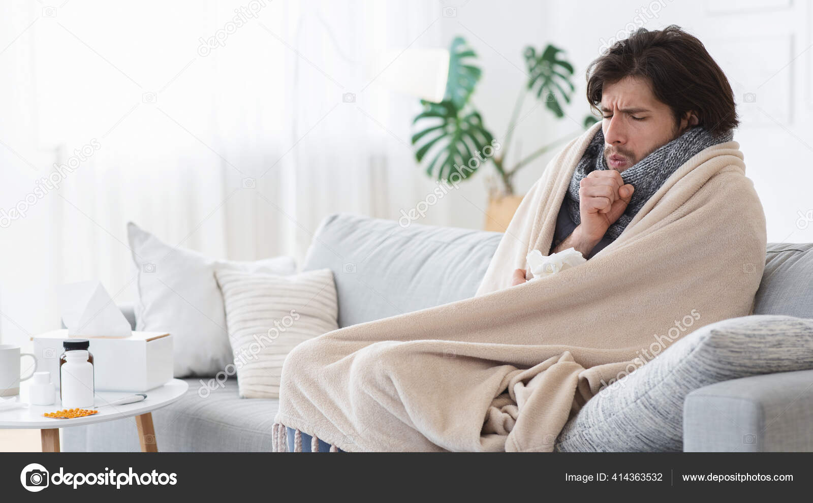 Sick man sitting on couch at living room, caughing Stock Photo by ...