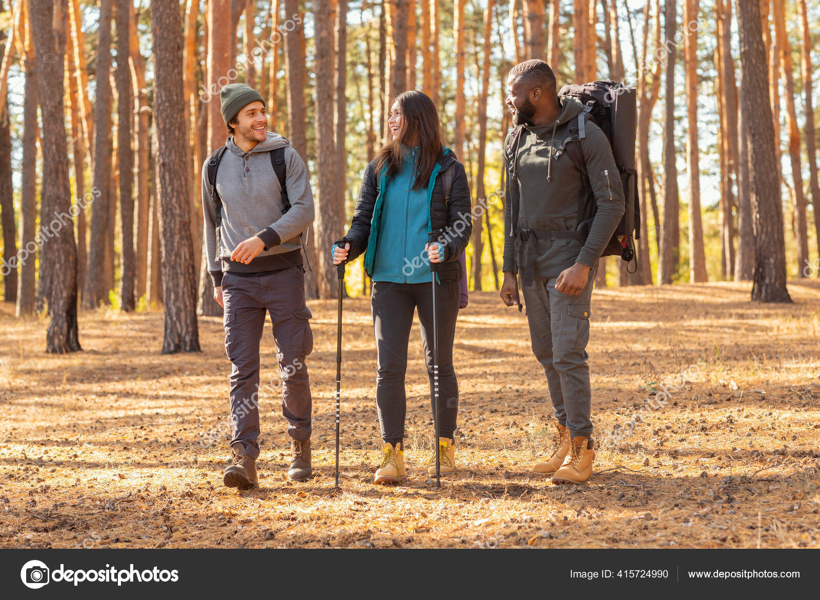 Young lifefull people with backpacks walking by forest Stock Photo by ...