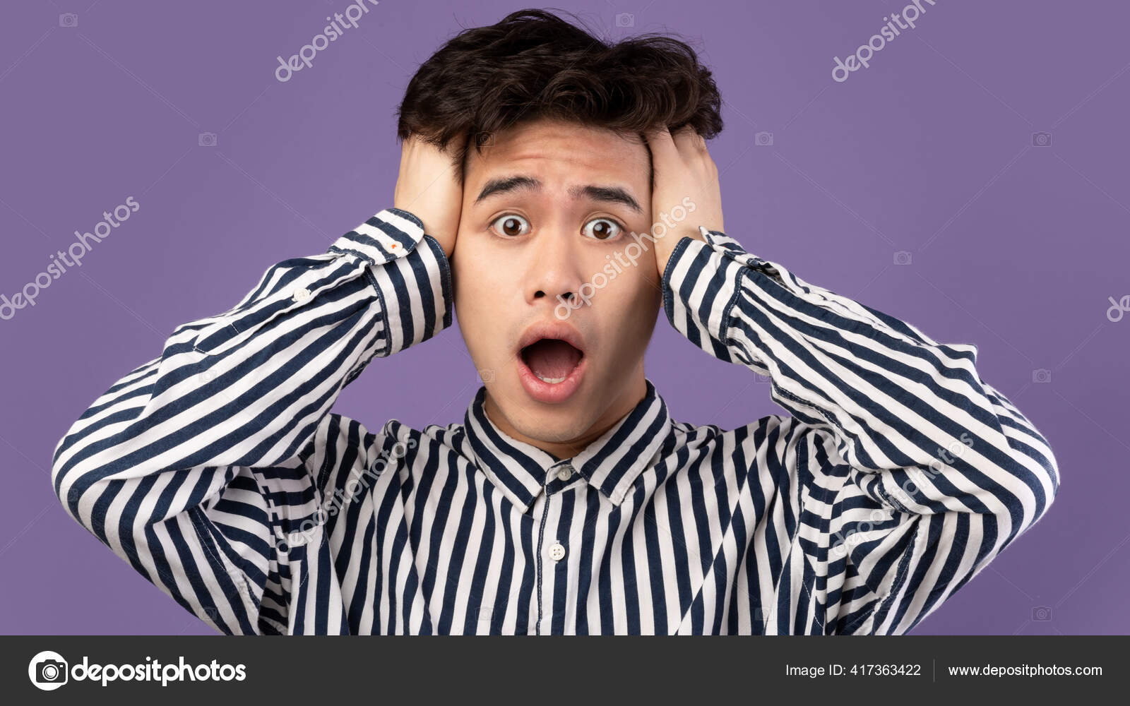 Scared asian man grimacing, screaming at purple studio Stock Photo by ...