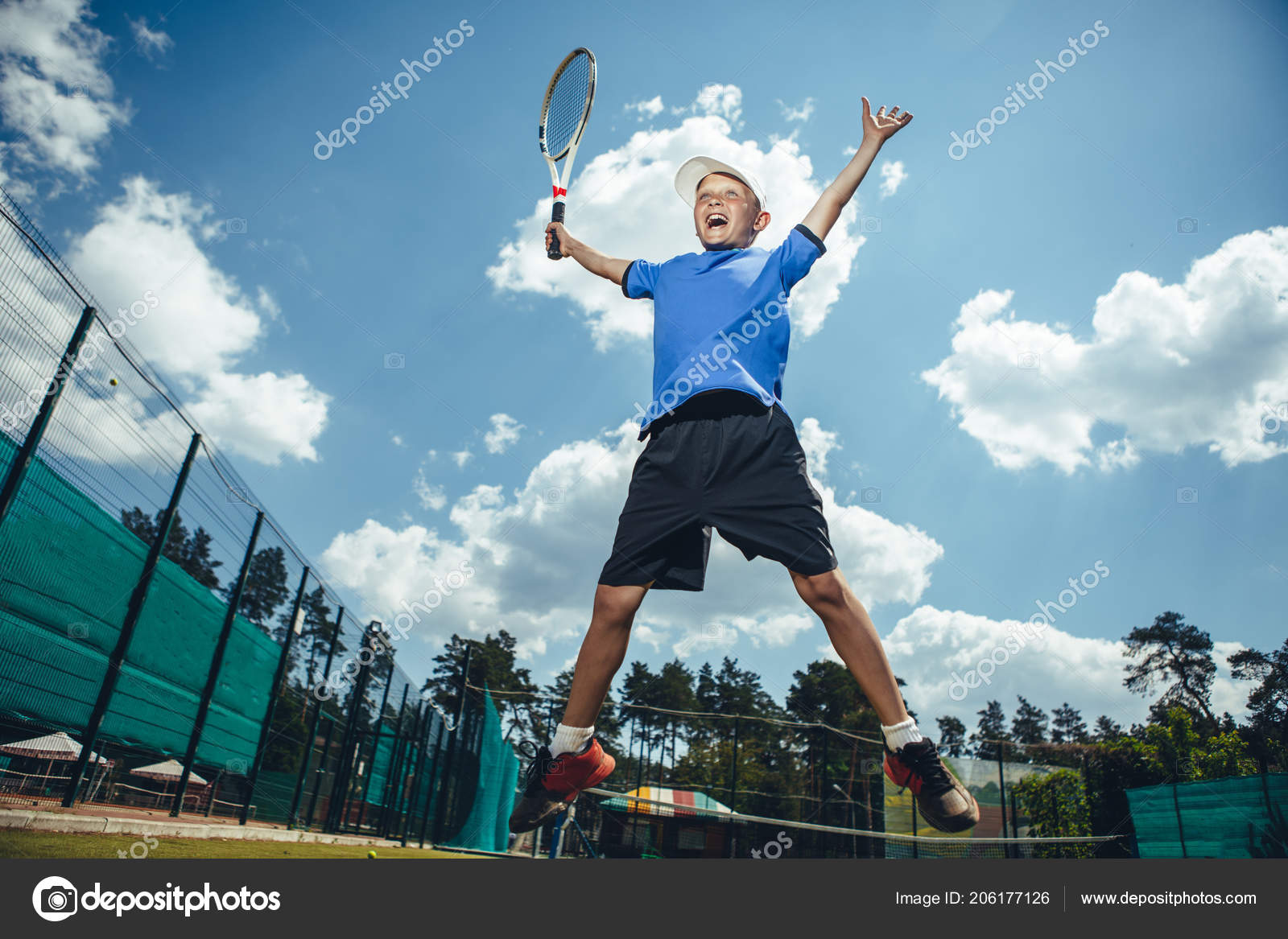 Outgoing boy playing tennis outdoor Stock Photo by ©iakovenko123 206177126