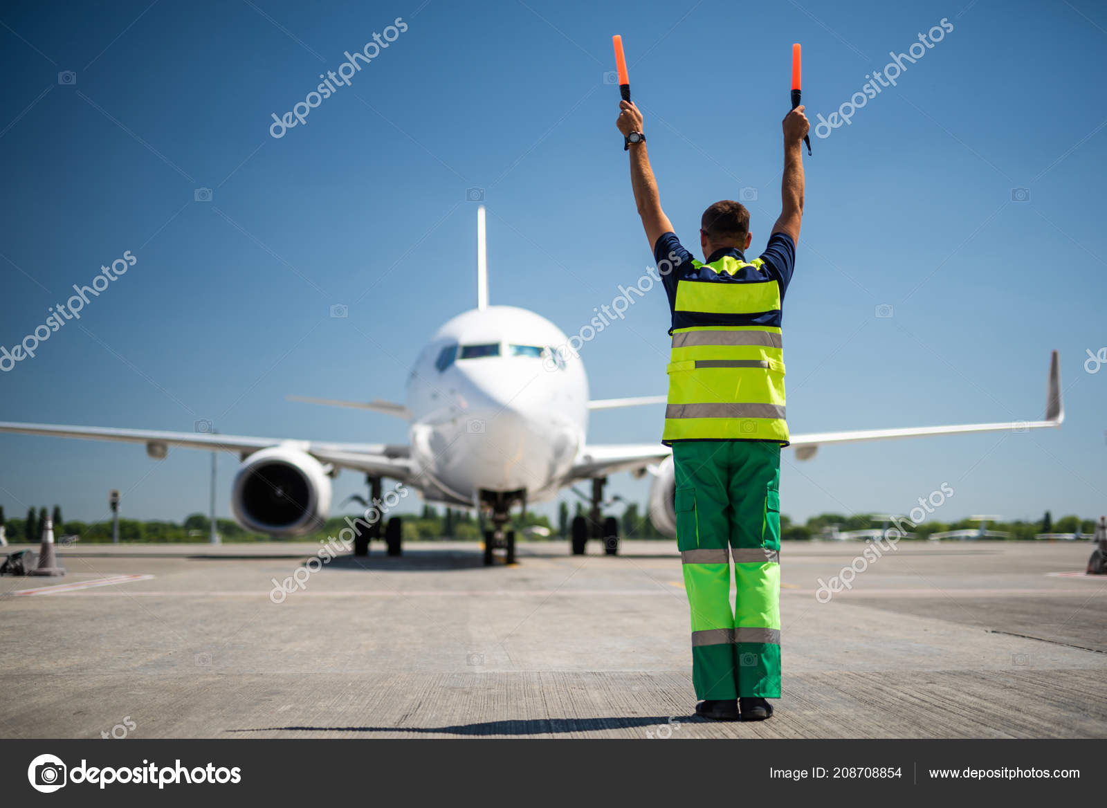 Aviation marshall raising hands and signaling Stock Photo by ...