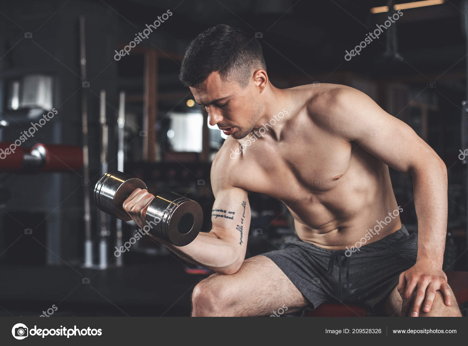 Strained man is training biceps in sport club — Stock Photo ...