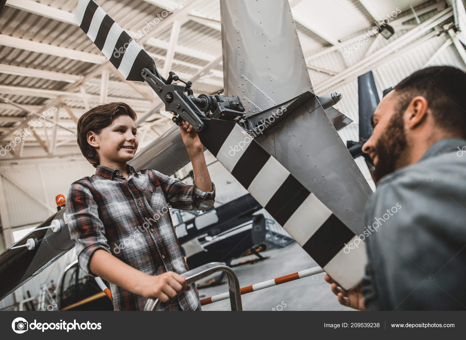 Satisfied child and father talking about helicopter Stock Photo by ...