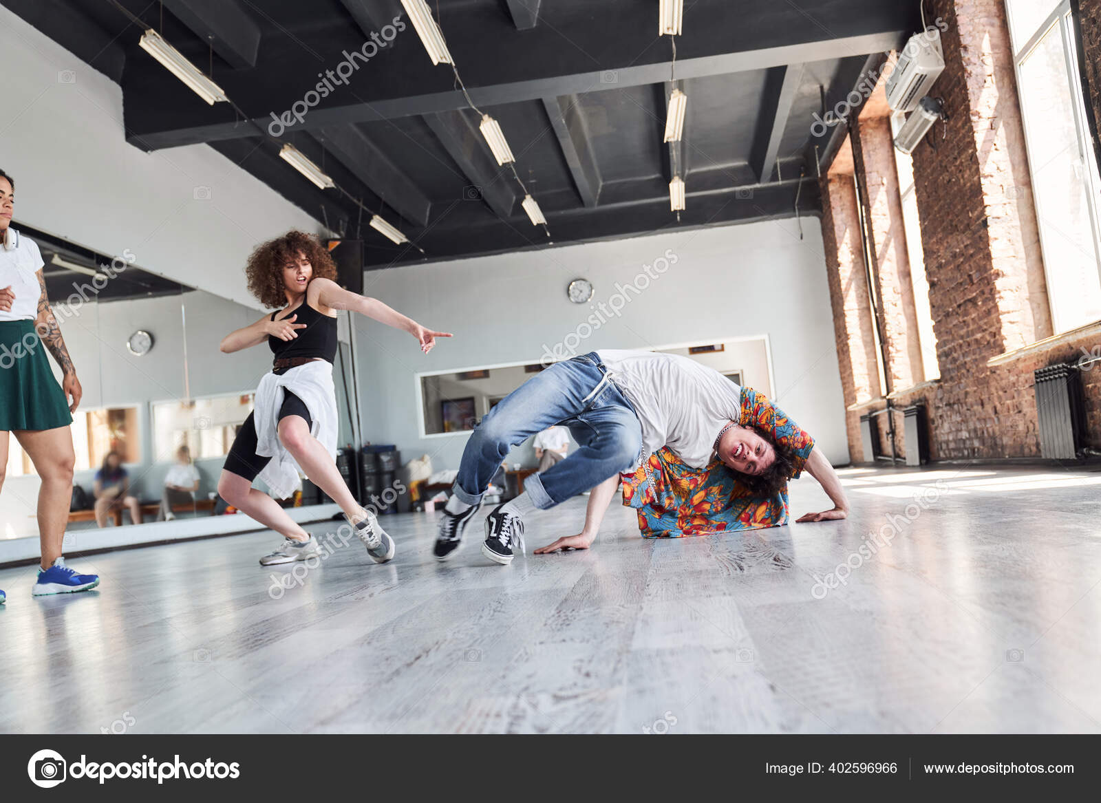 Jolly plastic guy practicing breakdance in studio Stock Photo by ...