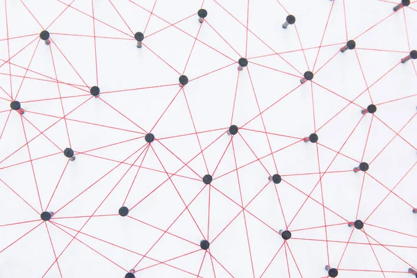 Connecting networks concept - network connected with yarn red on white ...