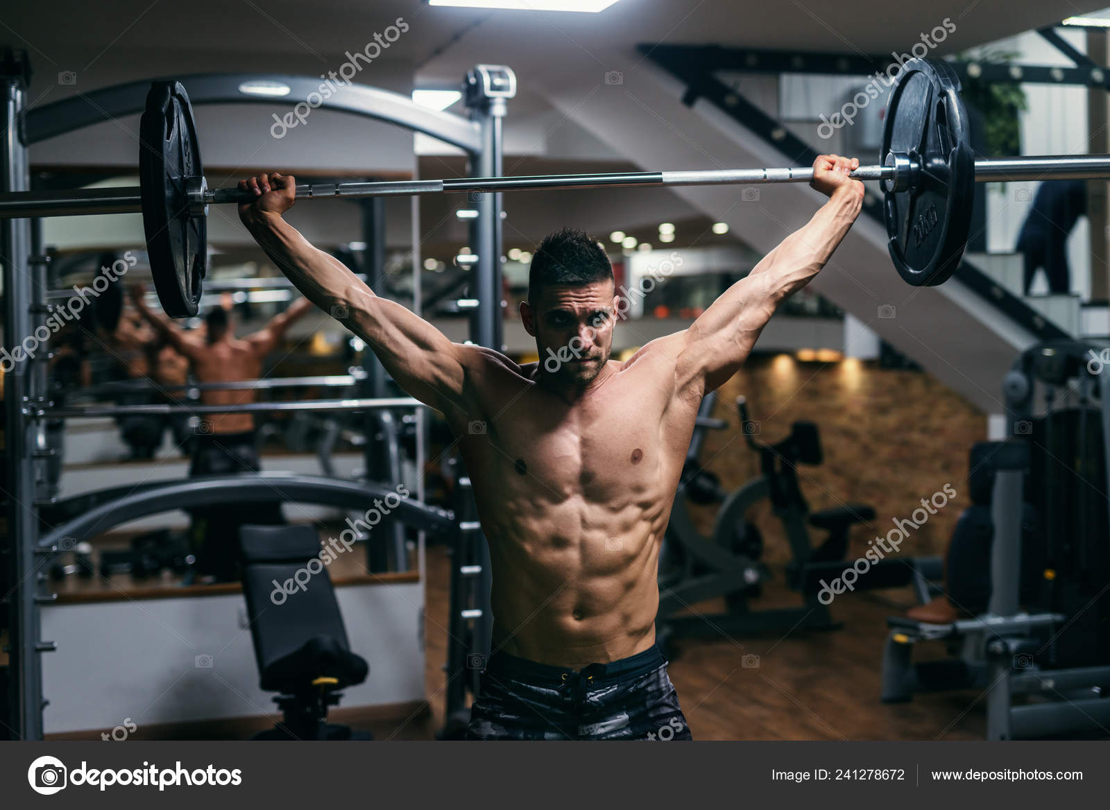 Young Strong Caucasian Shirtless Bodybuilder Lifting Barbells Gym