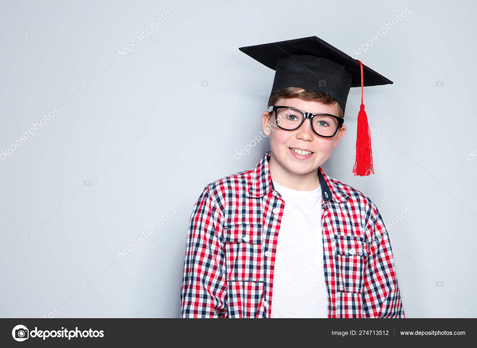 Young boy in graduation cap on grey background Stock Photo by ©5seconds ...