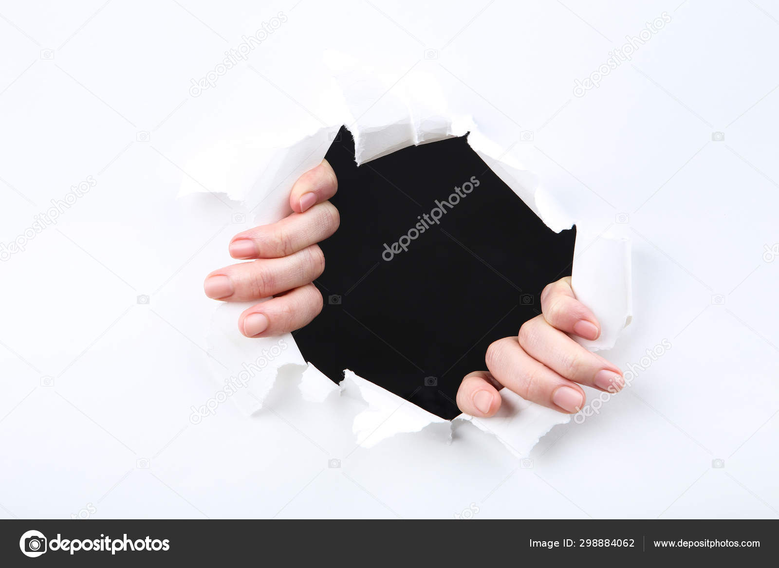 Hands tearing hole in white paper — Stock Photo © 5seconds #298884062