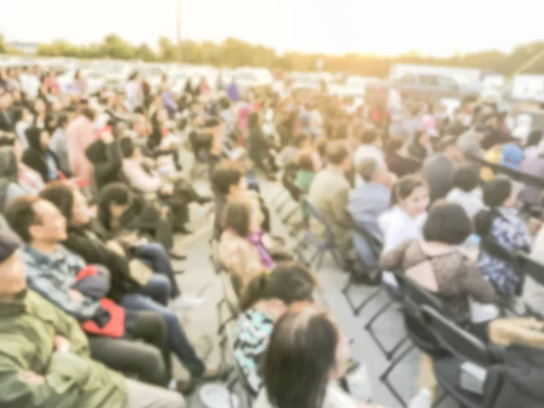 Blurred abstract crowd people standing and sitting on foldable camping ...