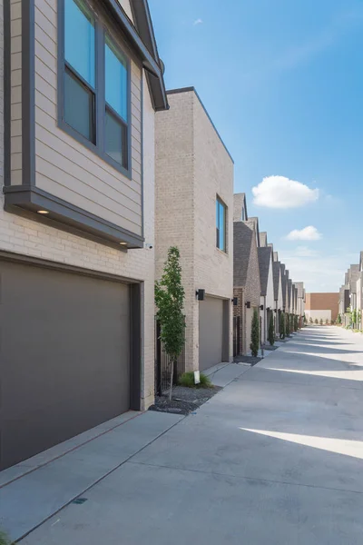 Clean and empty back alley of brand new row houses near downtown Dallas ...
