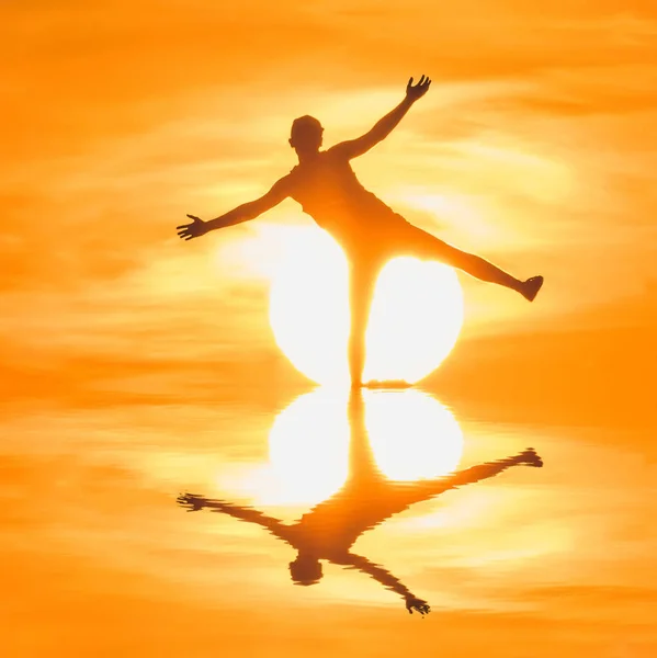 Young man having fun, standing on one leg, warm water sunset. - Stock ...