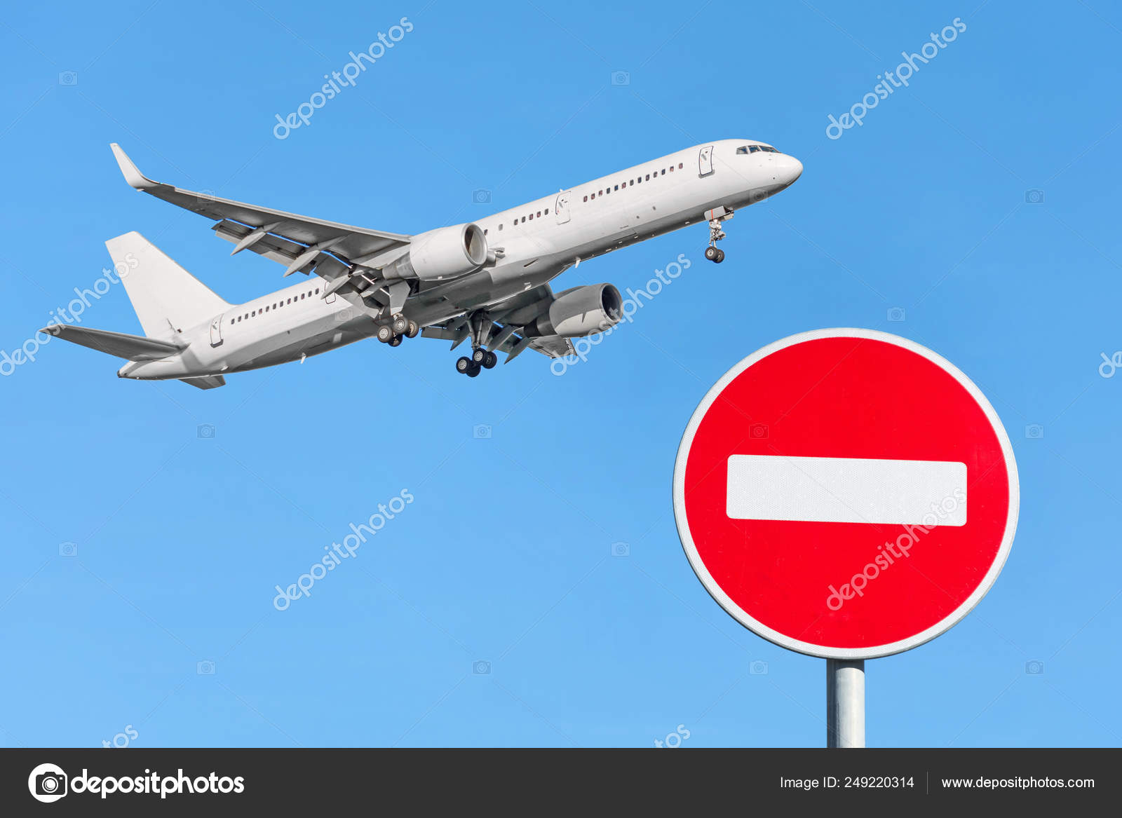 Red brick stop sign and an airplane flying in the sky. Flight Ban ...