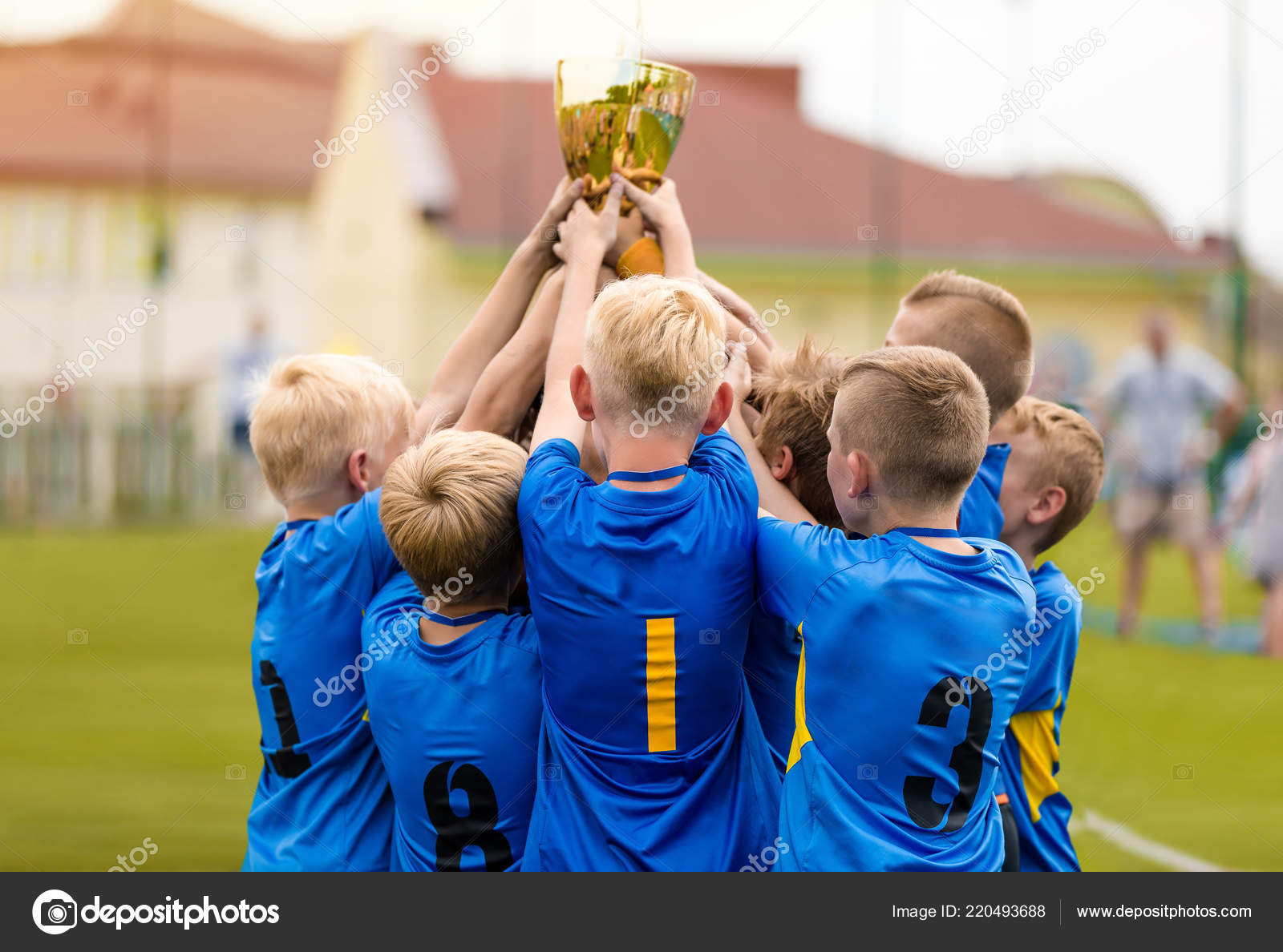 Young Soccer Players Holding Trophy Boys Celebrating Soccer Football Championship Stock Photo by ...