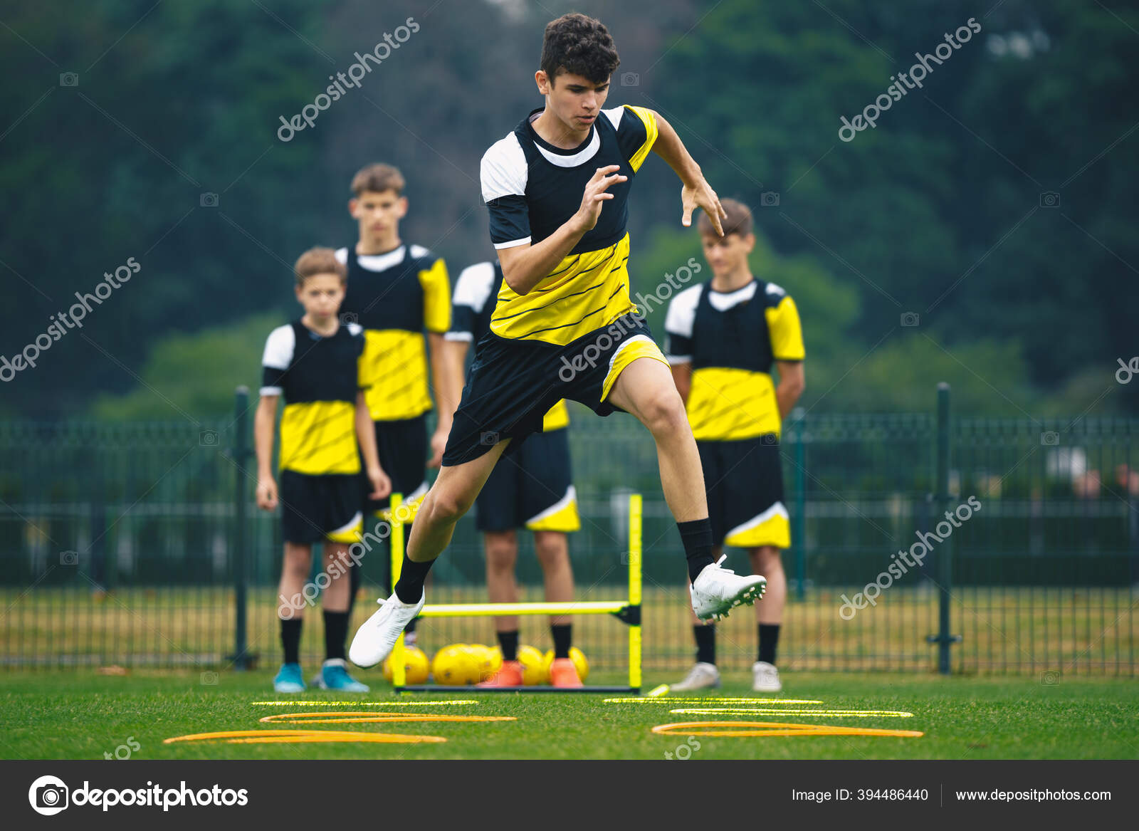 Young Footballer Training Jumping Obstacles Summer Soccer Camp Players ...