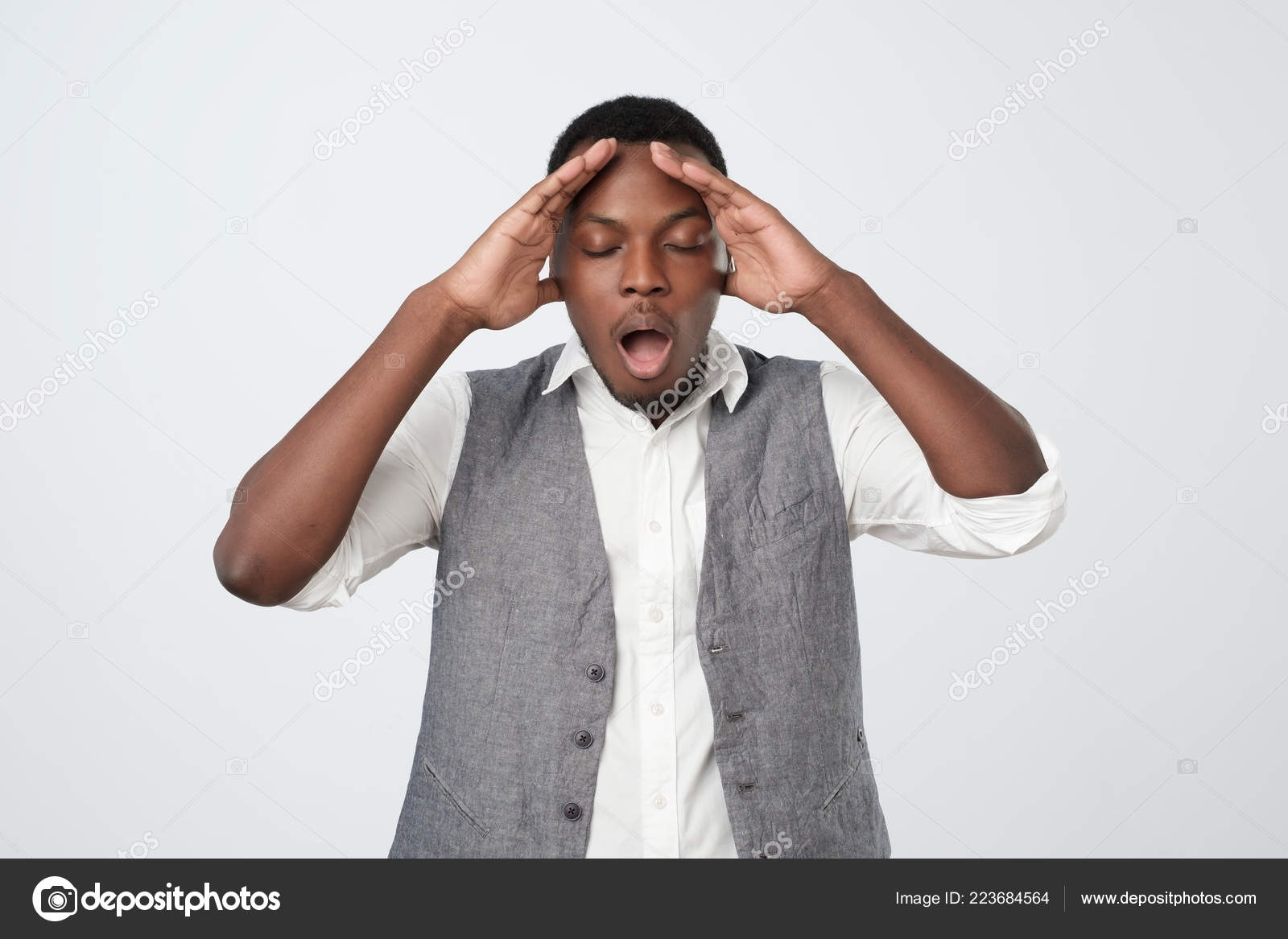 African young man, slapping hand on head having a duh moment isolated ...